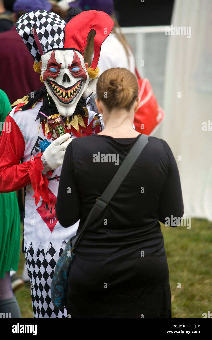 A couple in costume, one in a horror jester mask talk at the Standon ...