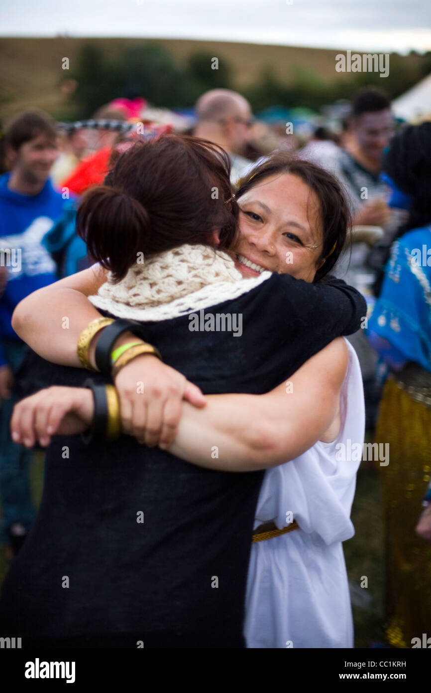 Two women greet each other with a hug at the Standon Calling Festival ...
