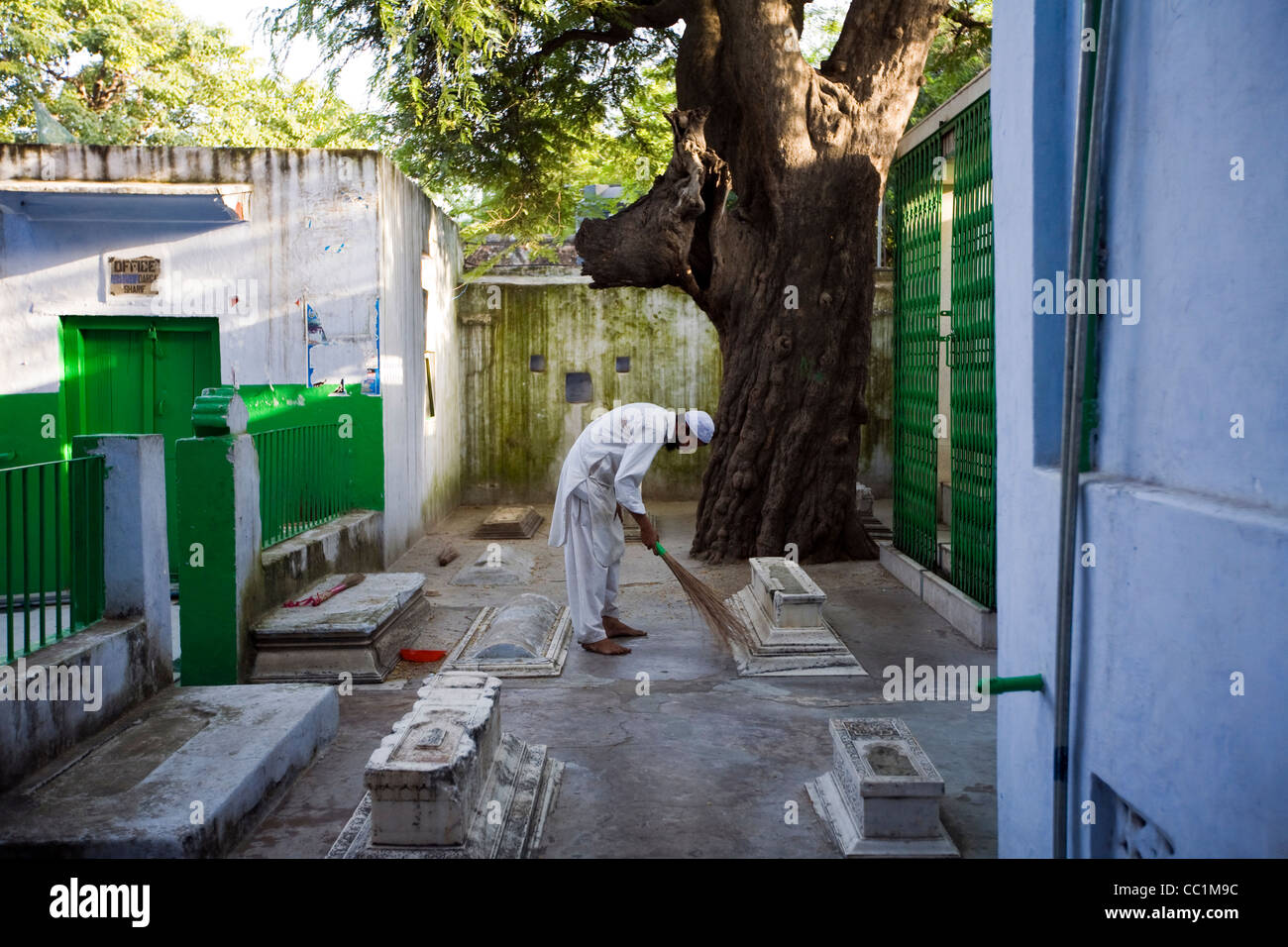 A man sweeps graves in the Qutbuddin Bakhtiar Kaki dargah in Mehrauli ...