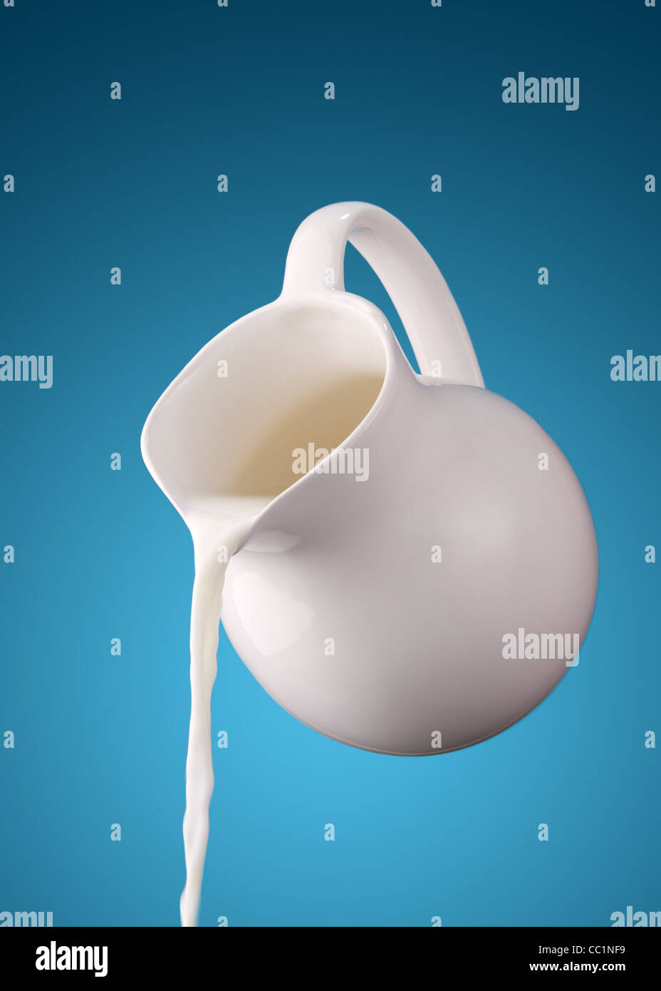 pitcher of milk on a blue background Stock Photo - Alamy