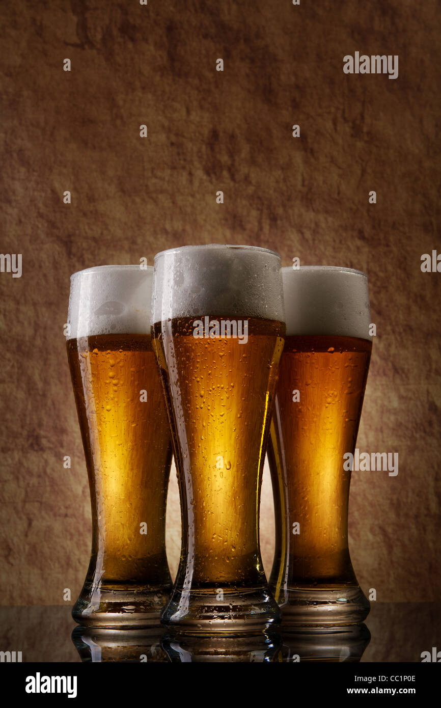 Three cold Beer into glass on a old stone Stock Photo - Alamy