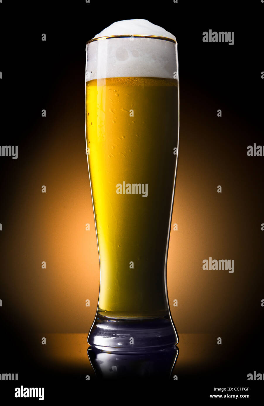 Beer into glass on a green gradient Stock Photo - Alamy
