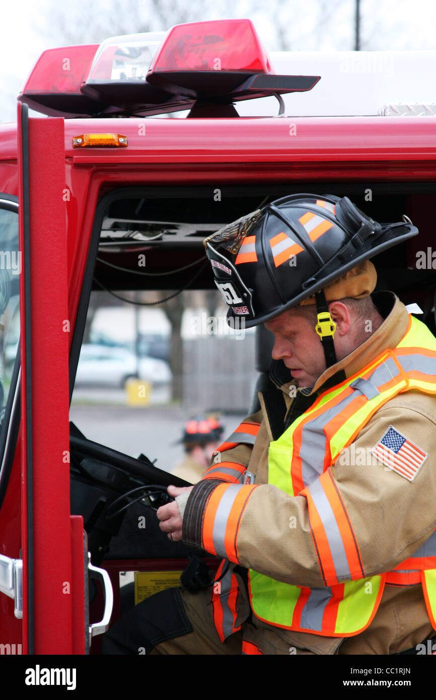 A firefighter holding a fire scene radio Stock Photo - Alamy
