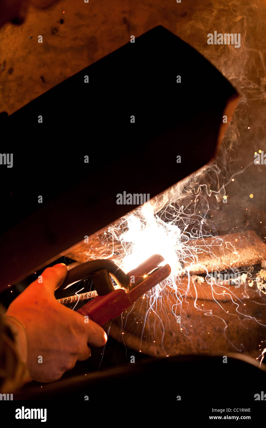 Melting welding electrode with spark at welder work Stock Photo - Alamy
