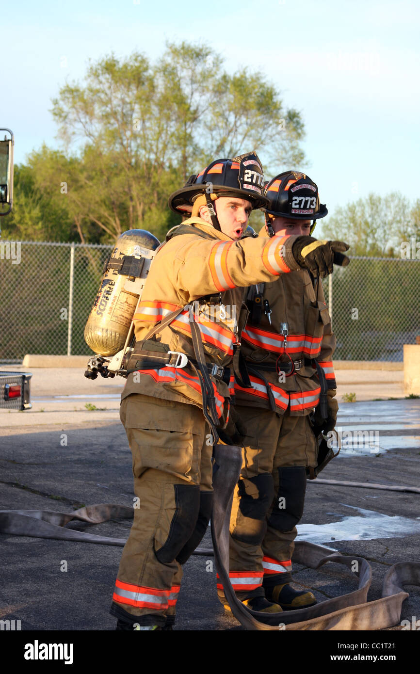 Firefighters pointing at an emergency scene Stock Photo - Alamy
