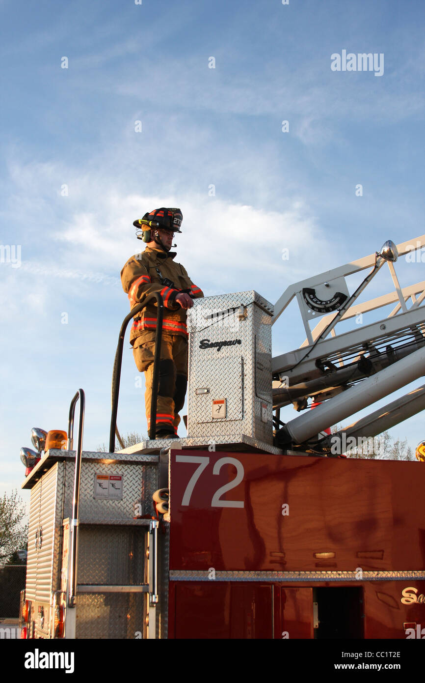 A firefighter at the controls of a ladder truck Stock Photo - Alamy