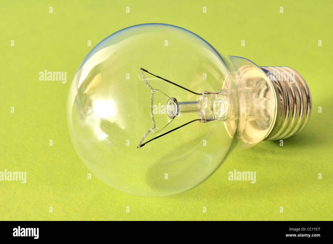 Green Power - Light bulb on green background Stock Photo - Alamy