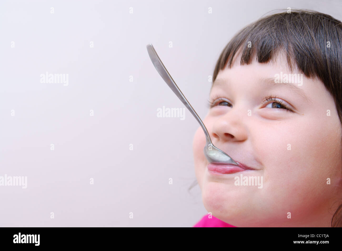girl playing with a spoon Stock Photo - Alamy