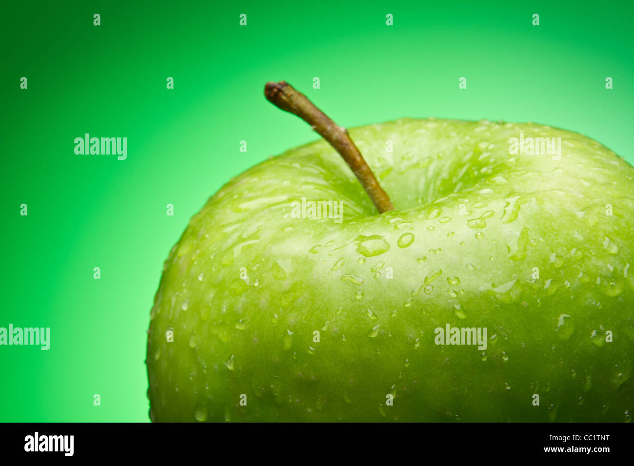 Green apple. Macro. on a green gradient Stock Photo - Alamy