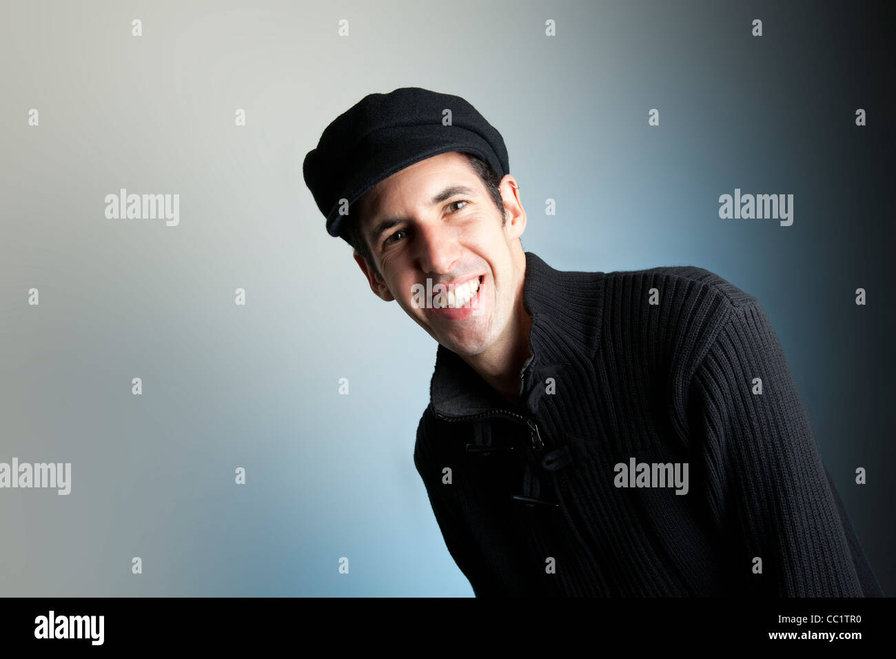 Man in 30's wearing a cap having fun laughing fashion Portrait in ...