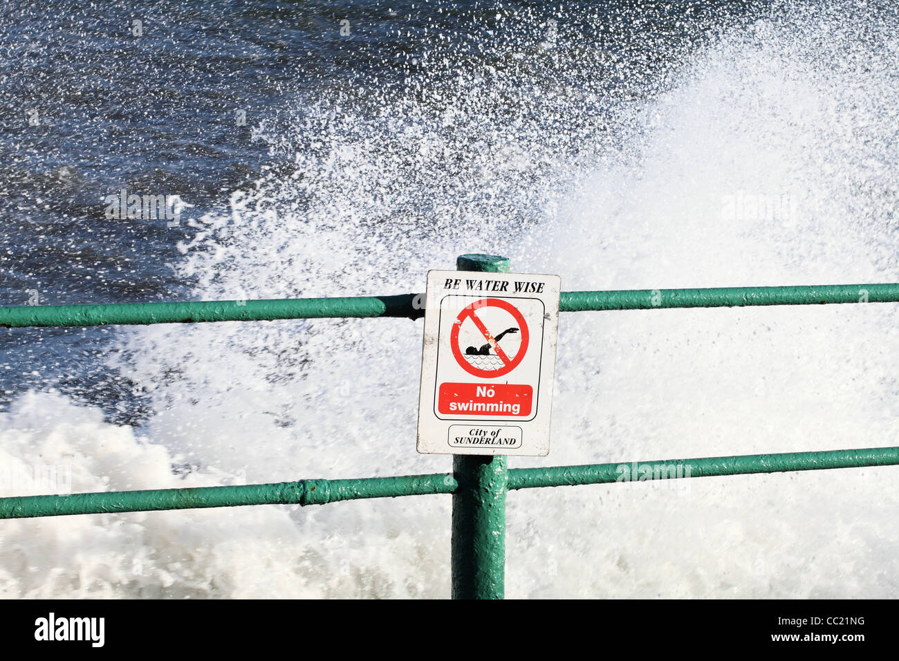 Danger sign Be Water Wise No Swimming with waves breaking in the ...