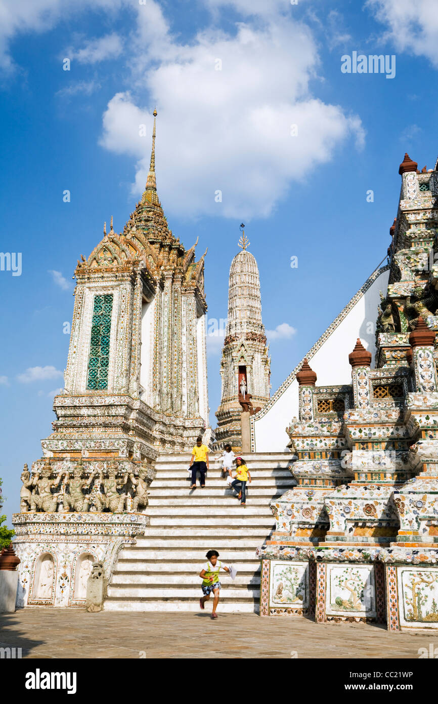Kids play on the steps of the prang (Khmer-style tower) at Wat Arun ...