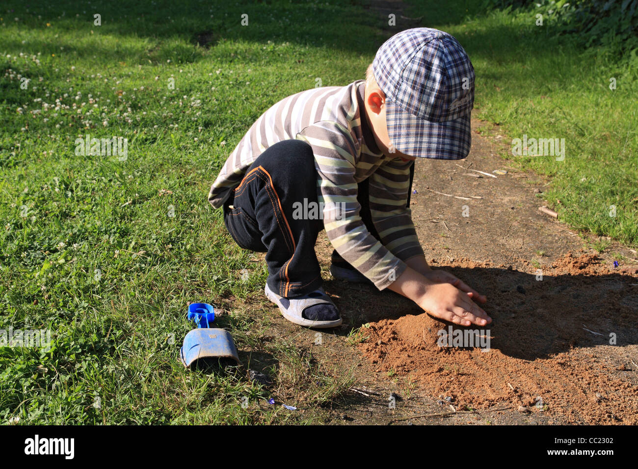 boy builds sand house Stock Photo - Alamy