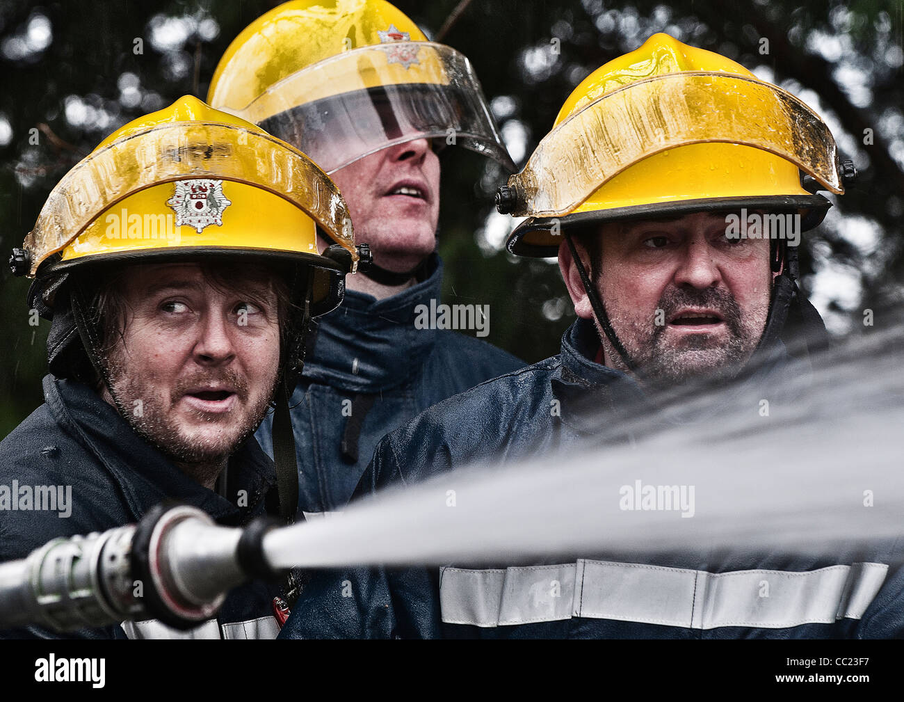 Firemen holding the hose Stock Photo - Alamy