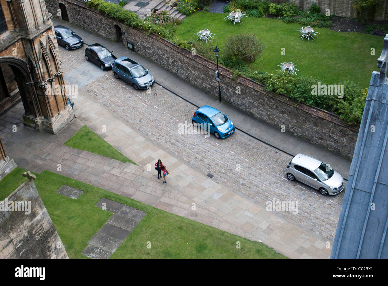 Looking down at two tourists on Minster Way from the roof of the nave ...