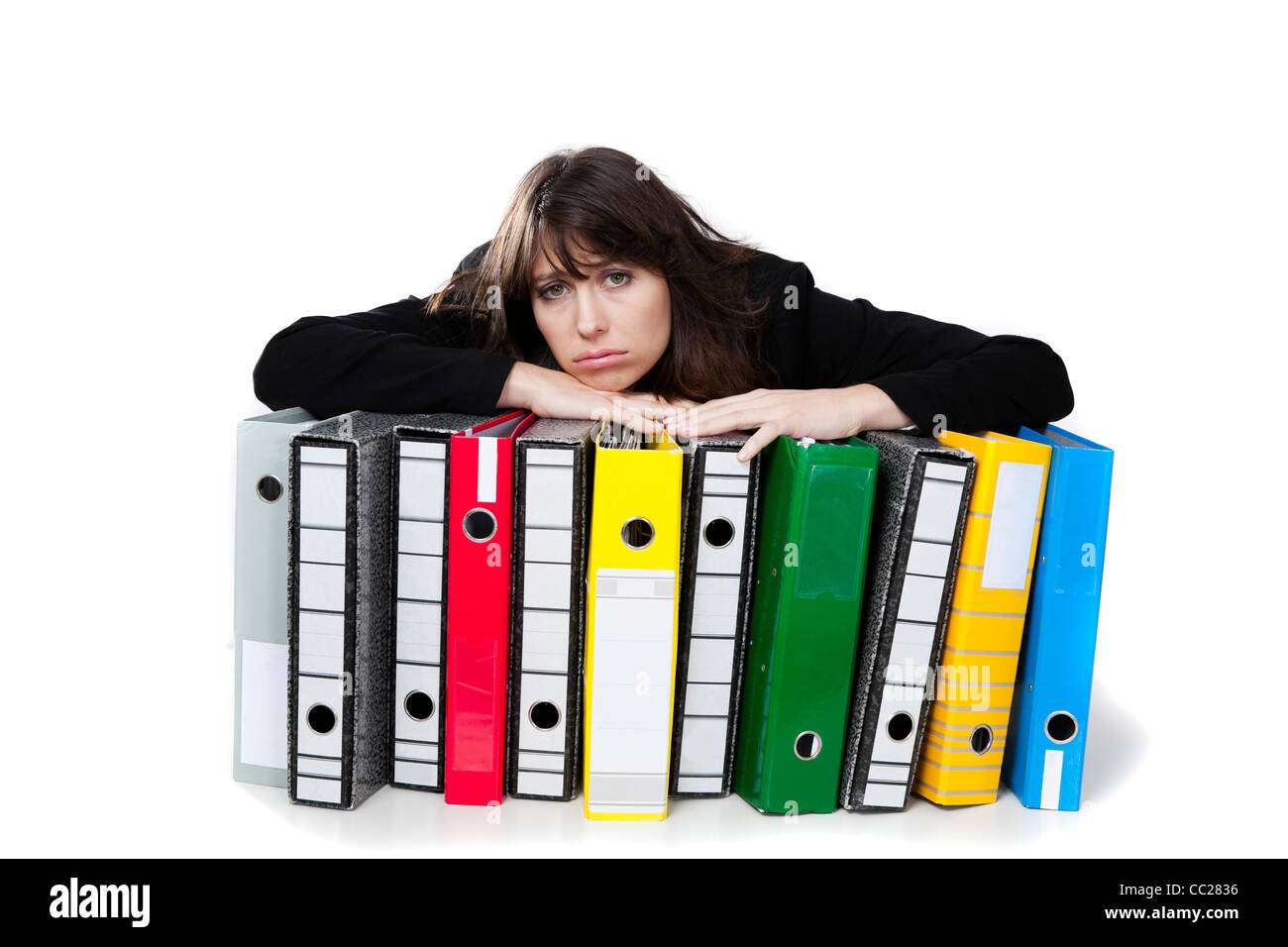 Stressed female office worker with folders. Studio shot, isolated on ...