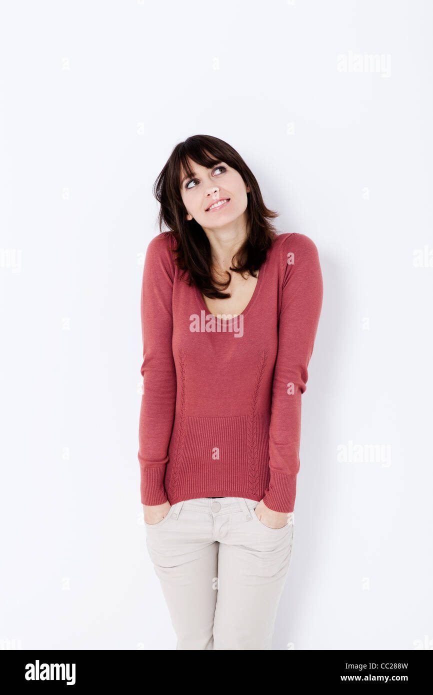 Beautiful woman standing and looking up. Studio shot Stock Photo - Alamy