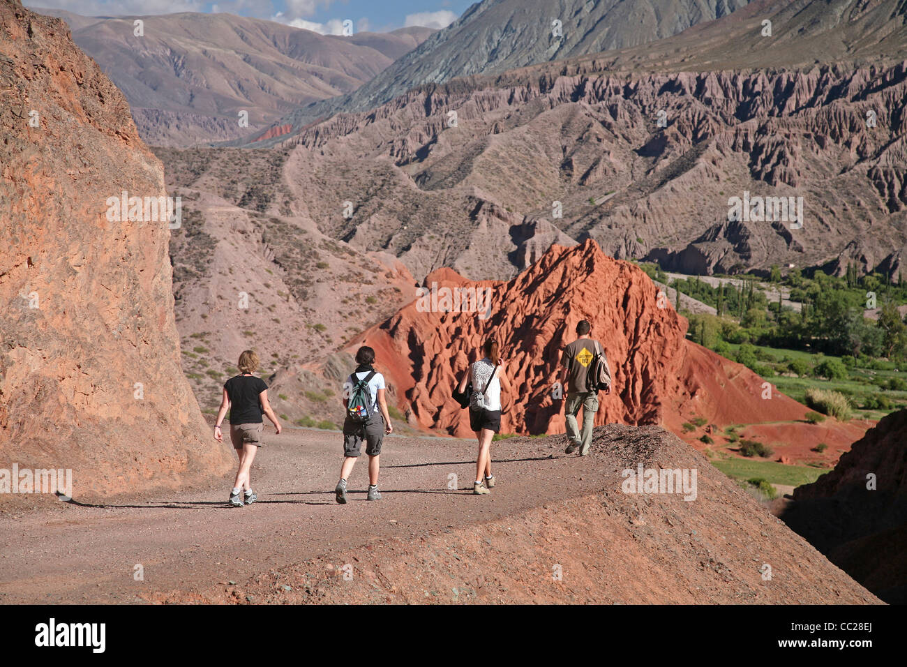 Tourists walking on hiking trail around the village Purmamarca, Jujuy ...