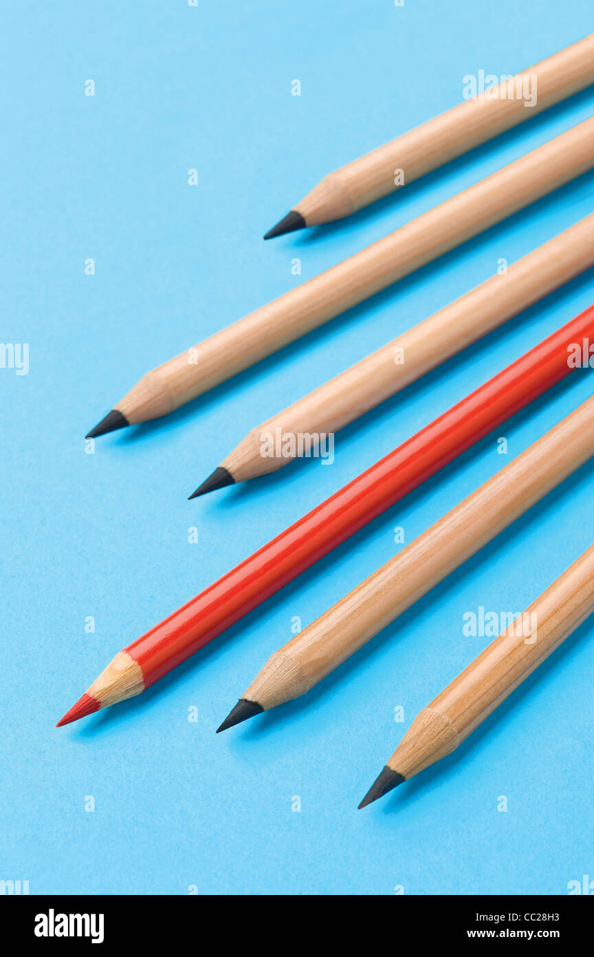 A red pencil amongst a group of lead pencils Stock Photo - Alamy