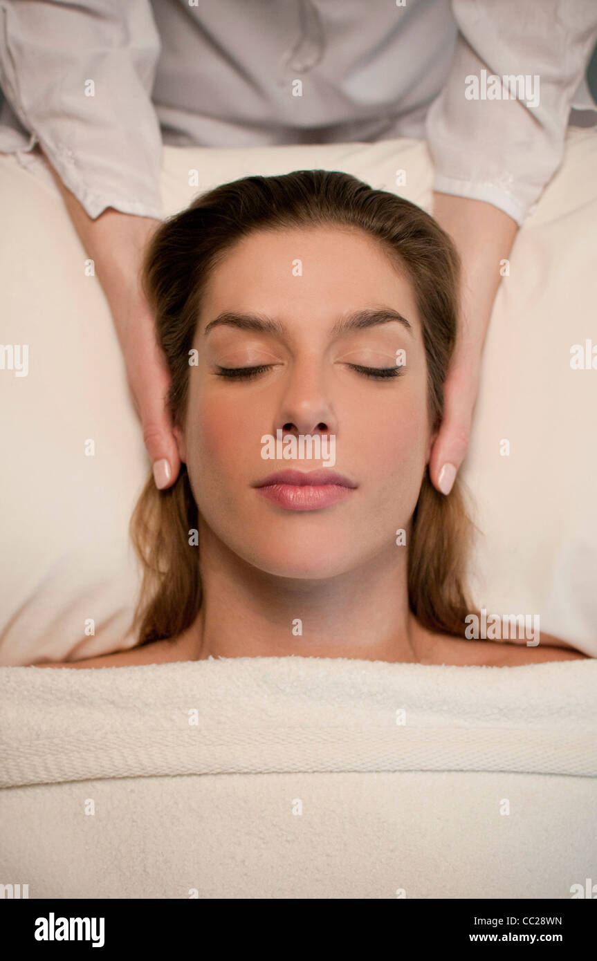 A young woman performing a Reiki treatment on a patient Stock Photo - Alamy