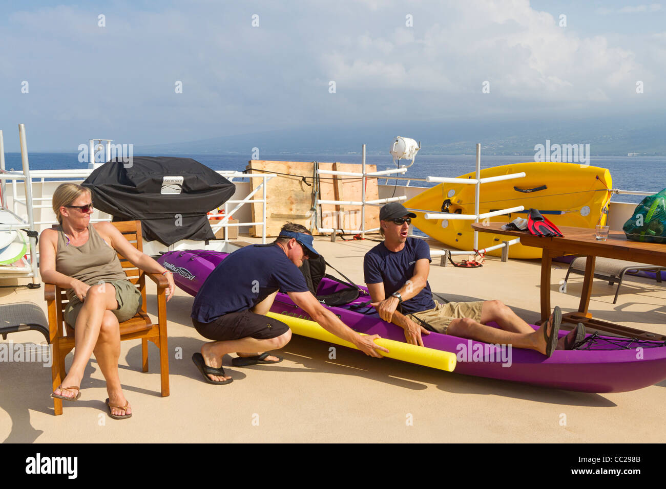 Expedition leaders demonstrate kayaks to cruise yacht passengers aboard ...