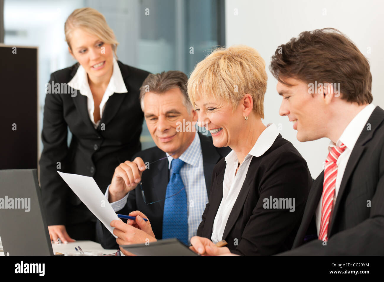 Business - team meeting in an office with laptop, the boss with his ...