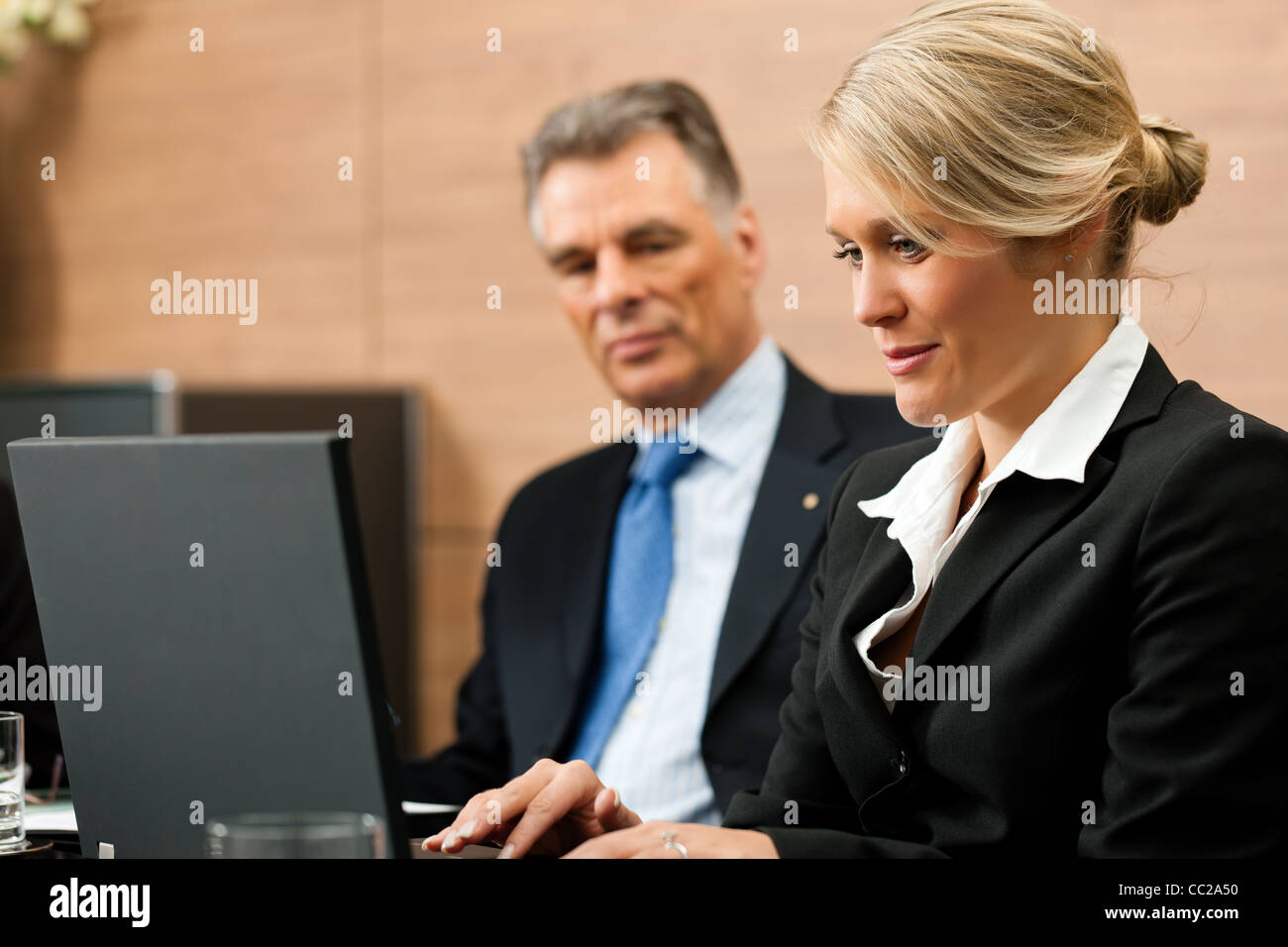 Lawyer with his secretary in his office, she is typing something Stock ...