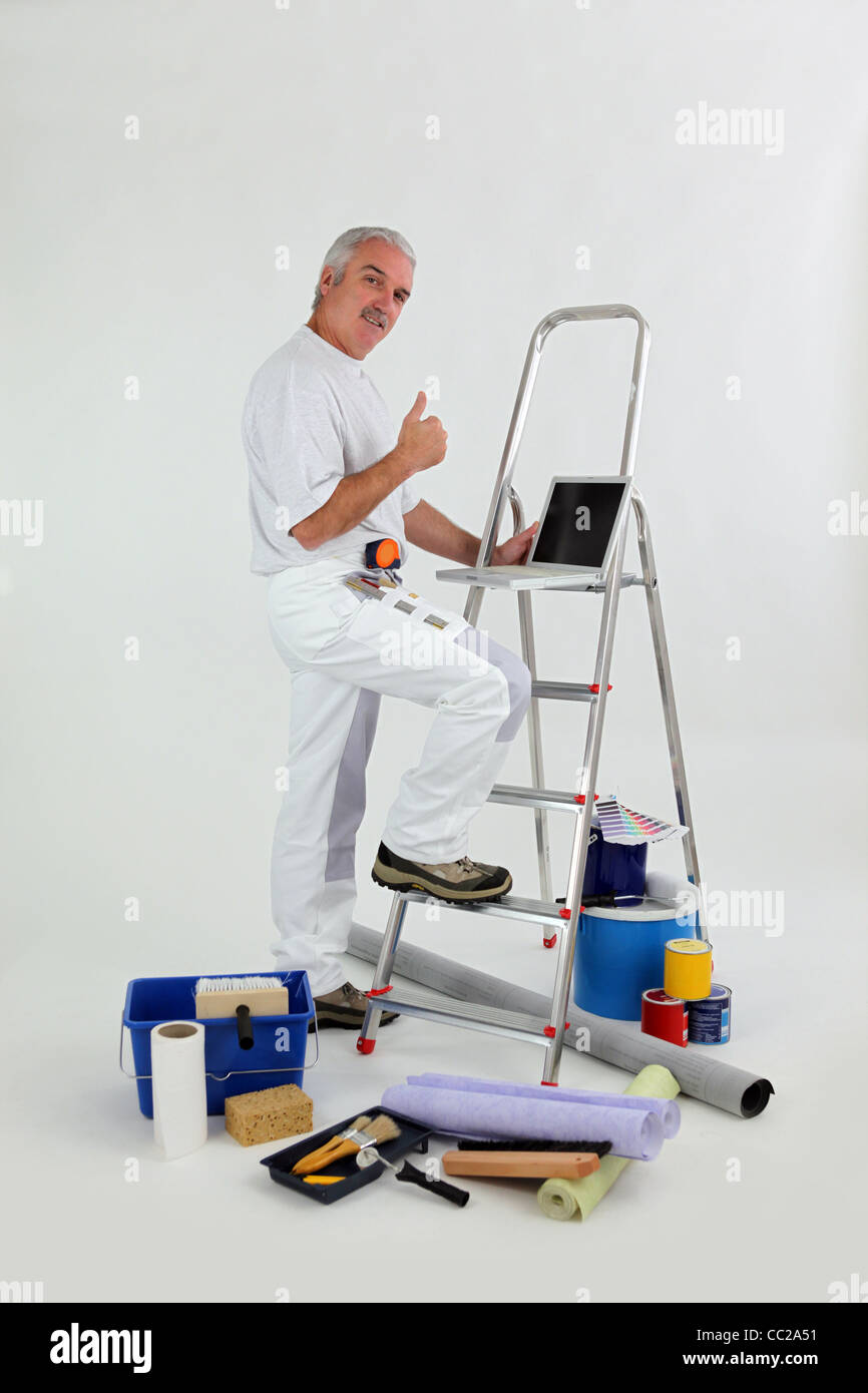 Male decorator with ladder giving thumbs-up Stock Photo - Alamy