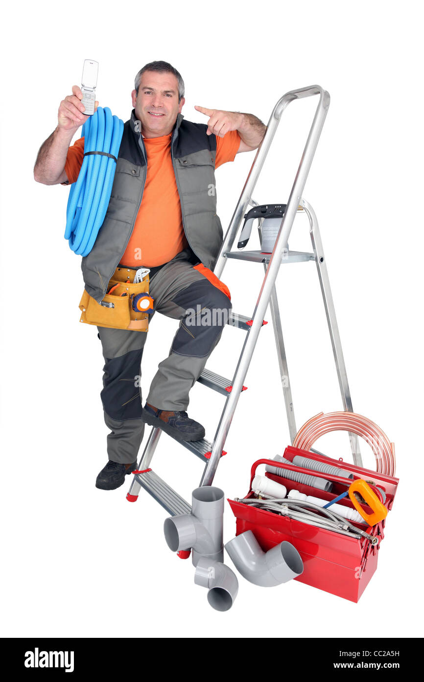 Handyman with a toolbox and cellphone Stock Photo - Alamy