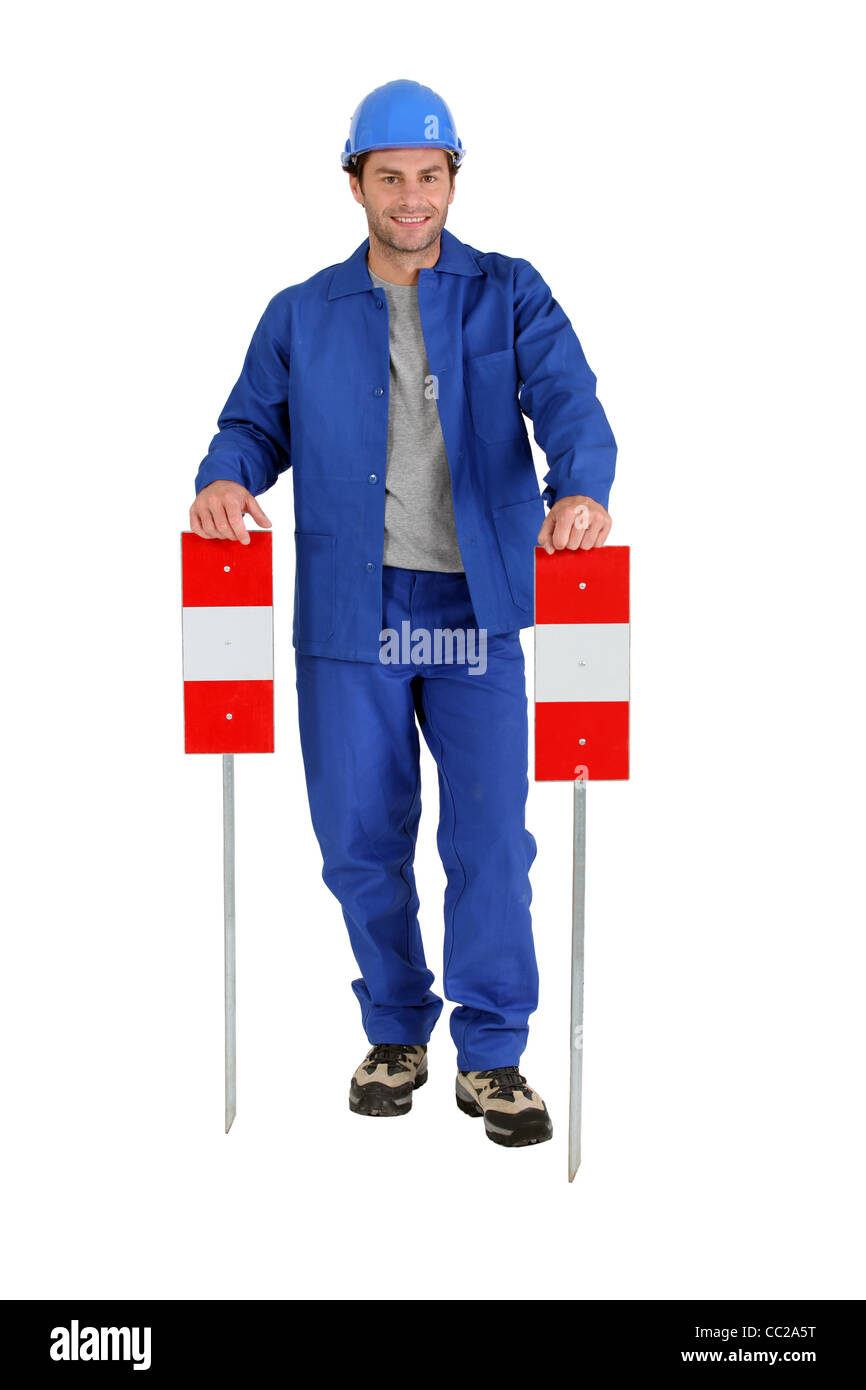 Builder holding road signs Stock Photo - Alamy