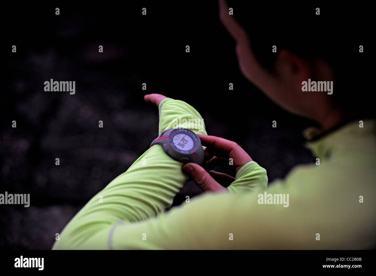Young woman female - Runner checking her stopwatch whilst out training ...