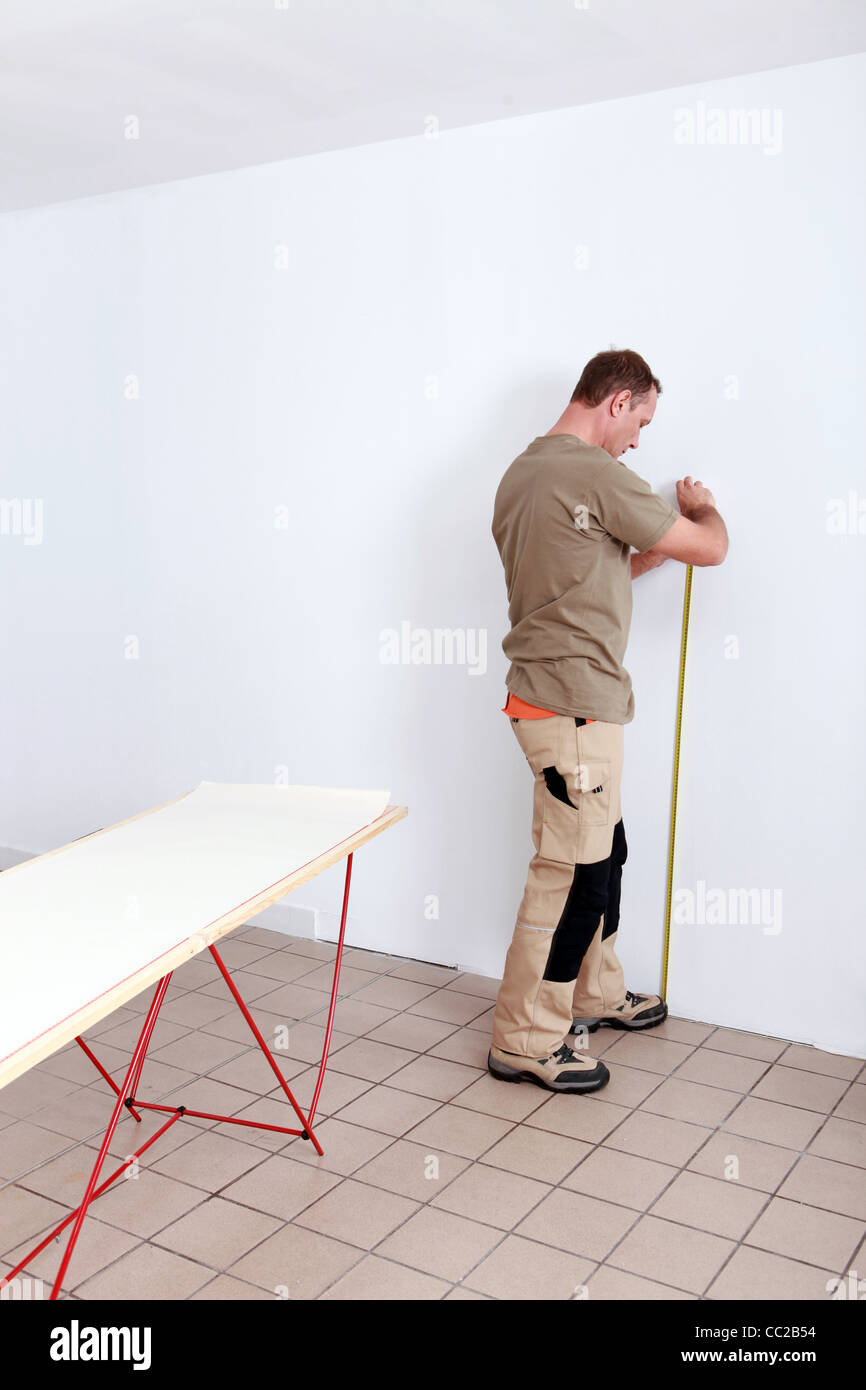 Man measuring wall Stock Photo - Alamy
