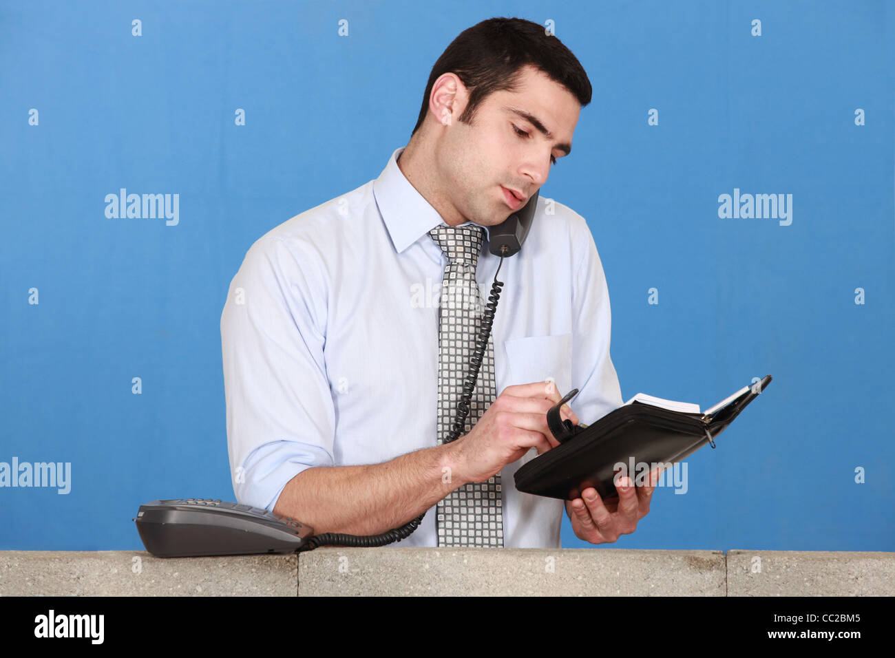 Man scheduling an appointment into his agenda Stock Photo - Alamy