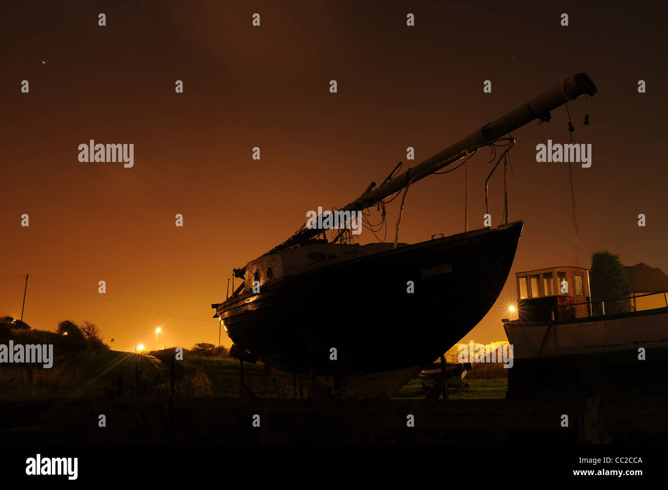 Boat docked on land at night Stock Photo - Alamy