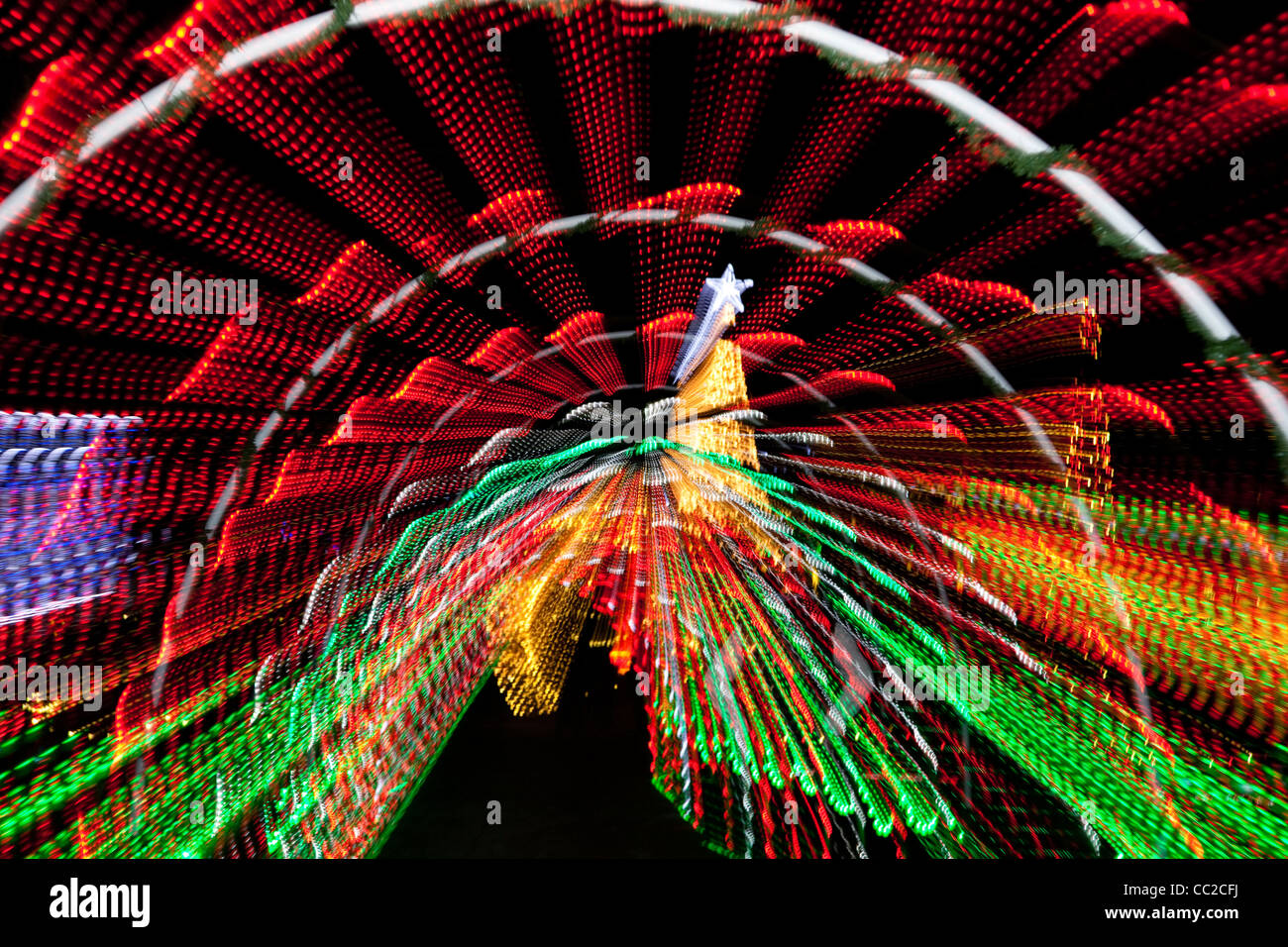 Abstract multi-coloured pattern of electric lights radiating out from a ...