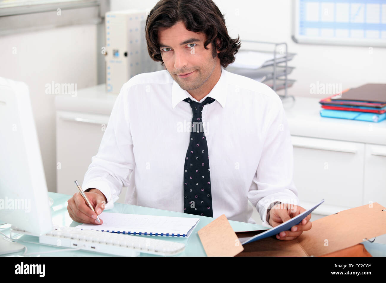 Handsome man doing his paperwork Stock Photo - Alamy