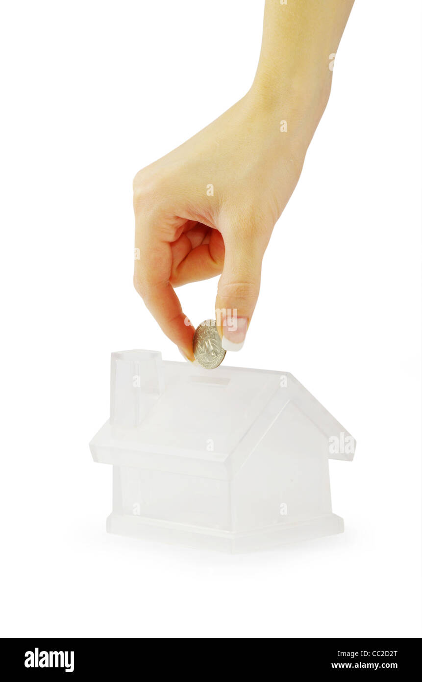Hand with coin and house bank isolated on white background Stock Photo ...