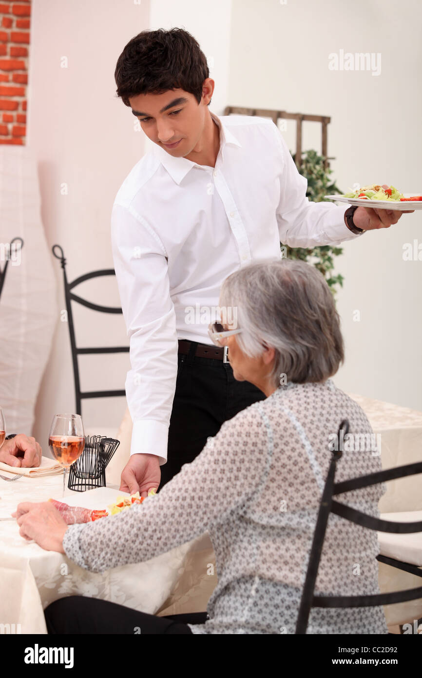Waiter serving food Stock Photo - Alamy