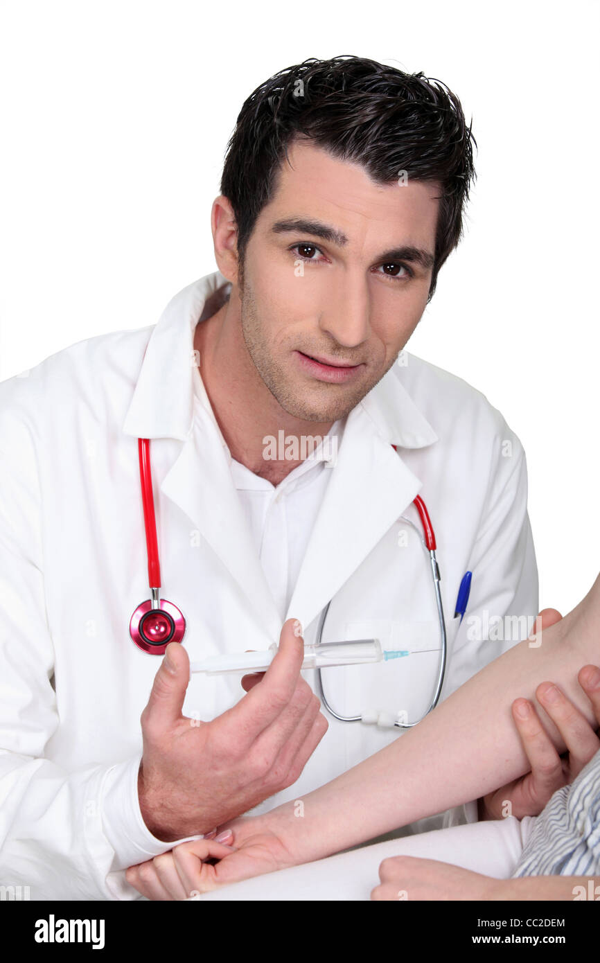 Young doctor giving an injection to a patient Stock Photo - Alamy