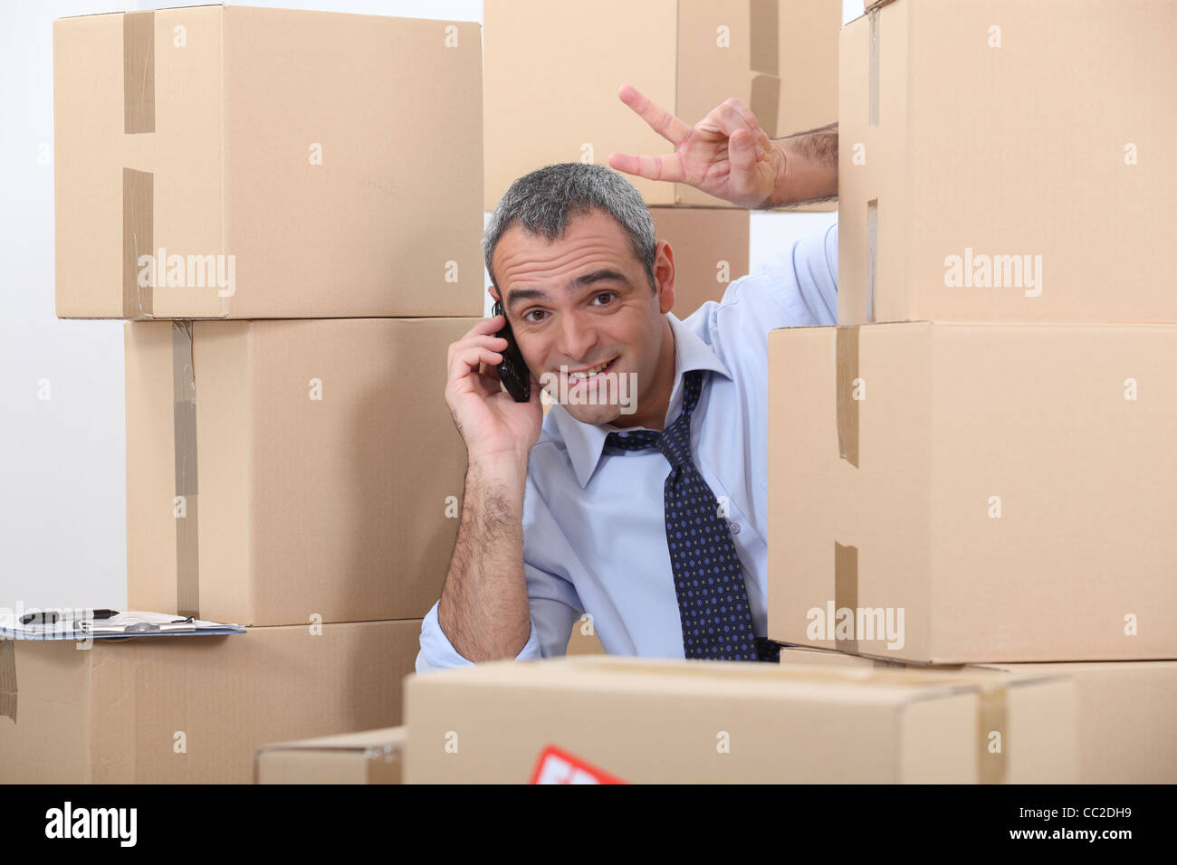 Man surrounded by cardboard boxes Stock Photo - Alamy