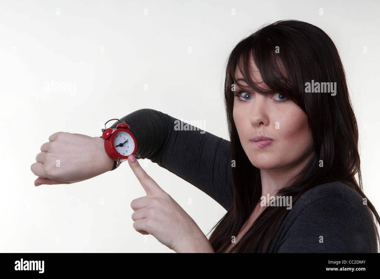 woman looking a watch thinking someone running late Stock Photo - Alamy