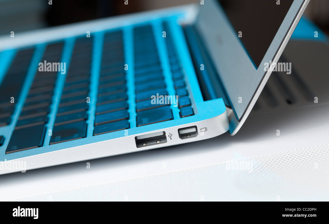 USB socket and mini display port in the side of metal laptop lit with a ...