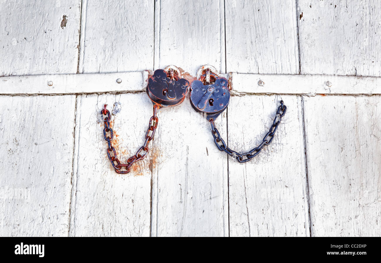 Pair of rusty old padlock and chain fastening a door opening Stock ...