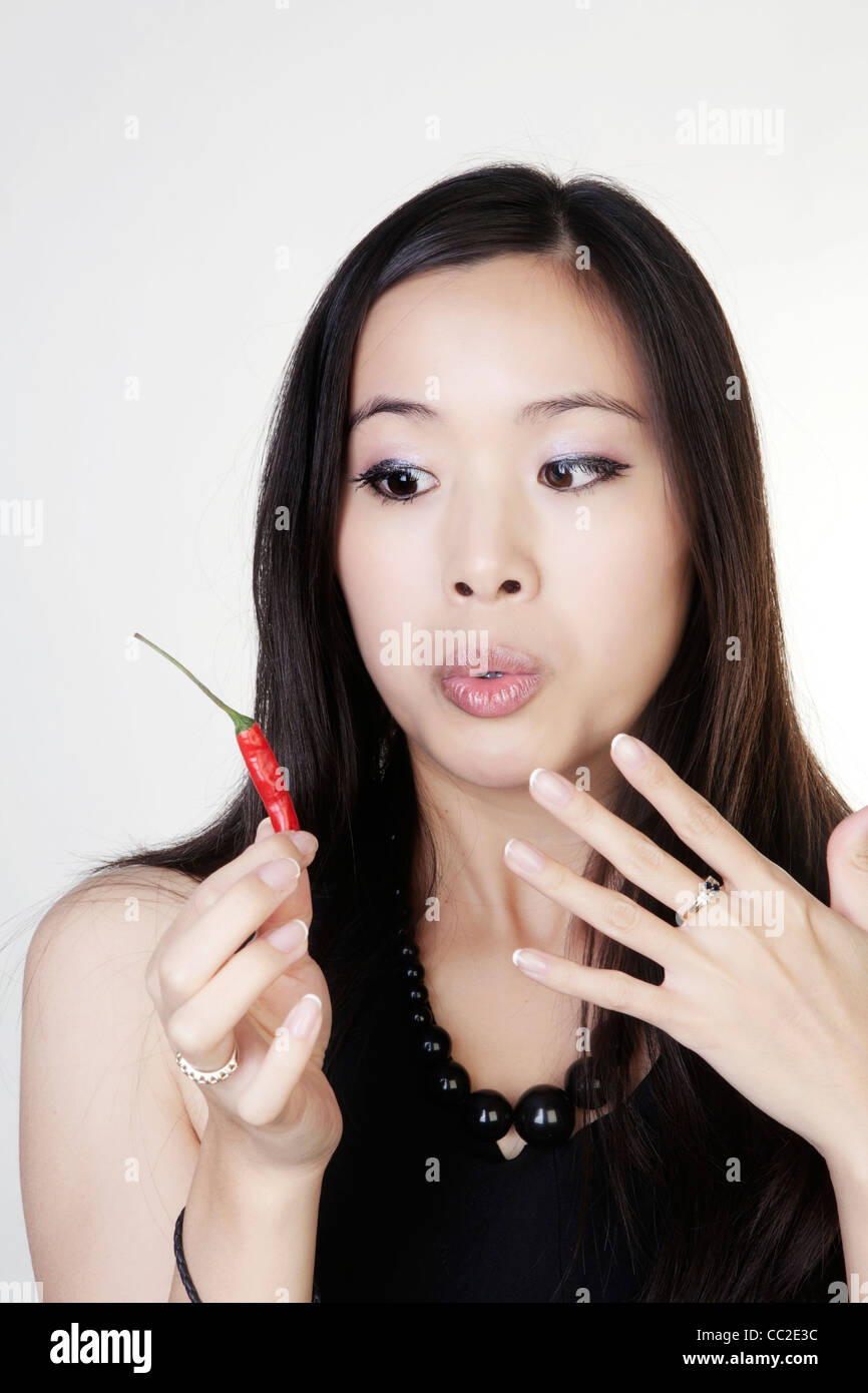picture of lovely woman with a hot fresh chilli Stock Photo - Alamy