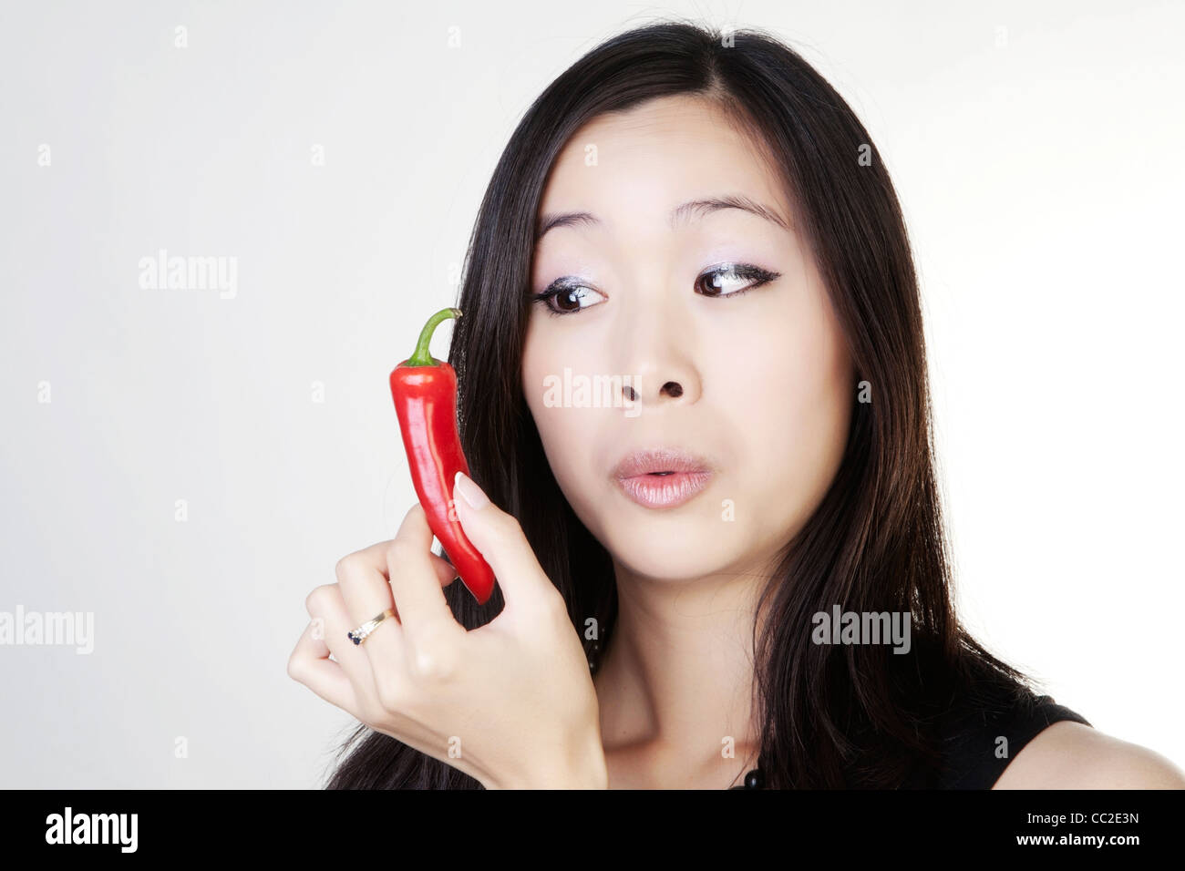 picture of lovely woman with a hot fresh chilli Stock Photo - Alamy