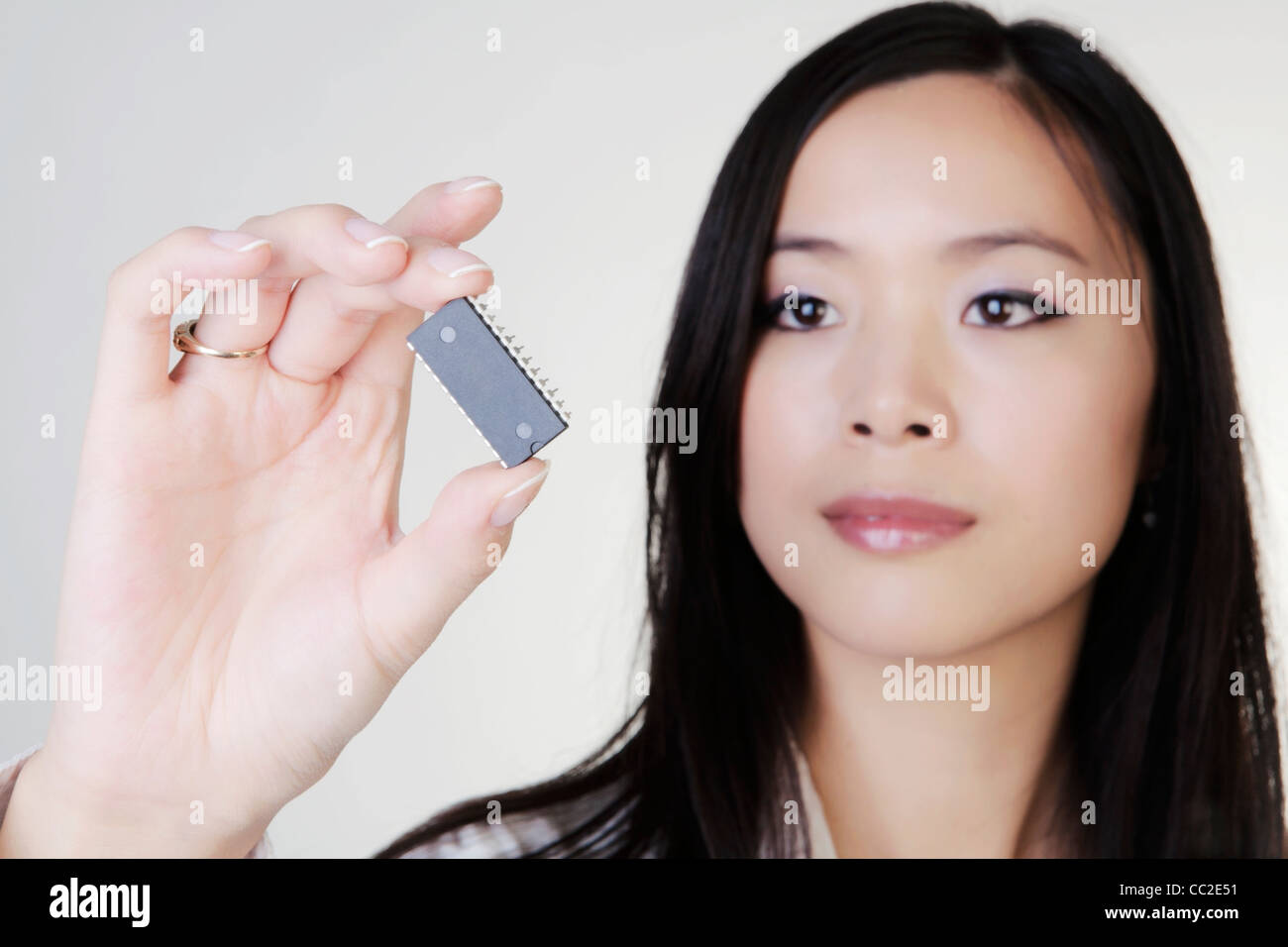 woman holding in her hand a small computer chip Stock Photo - Alamy