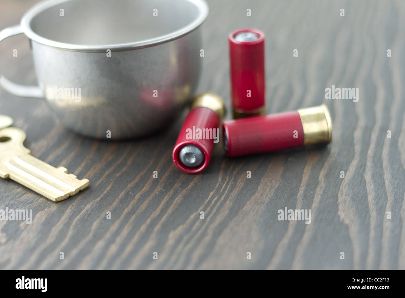 Tin prison cup with shotgun shells and cell key Stock Photo - Alamy