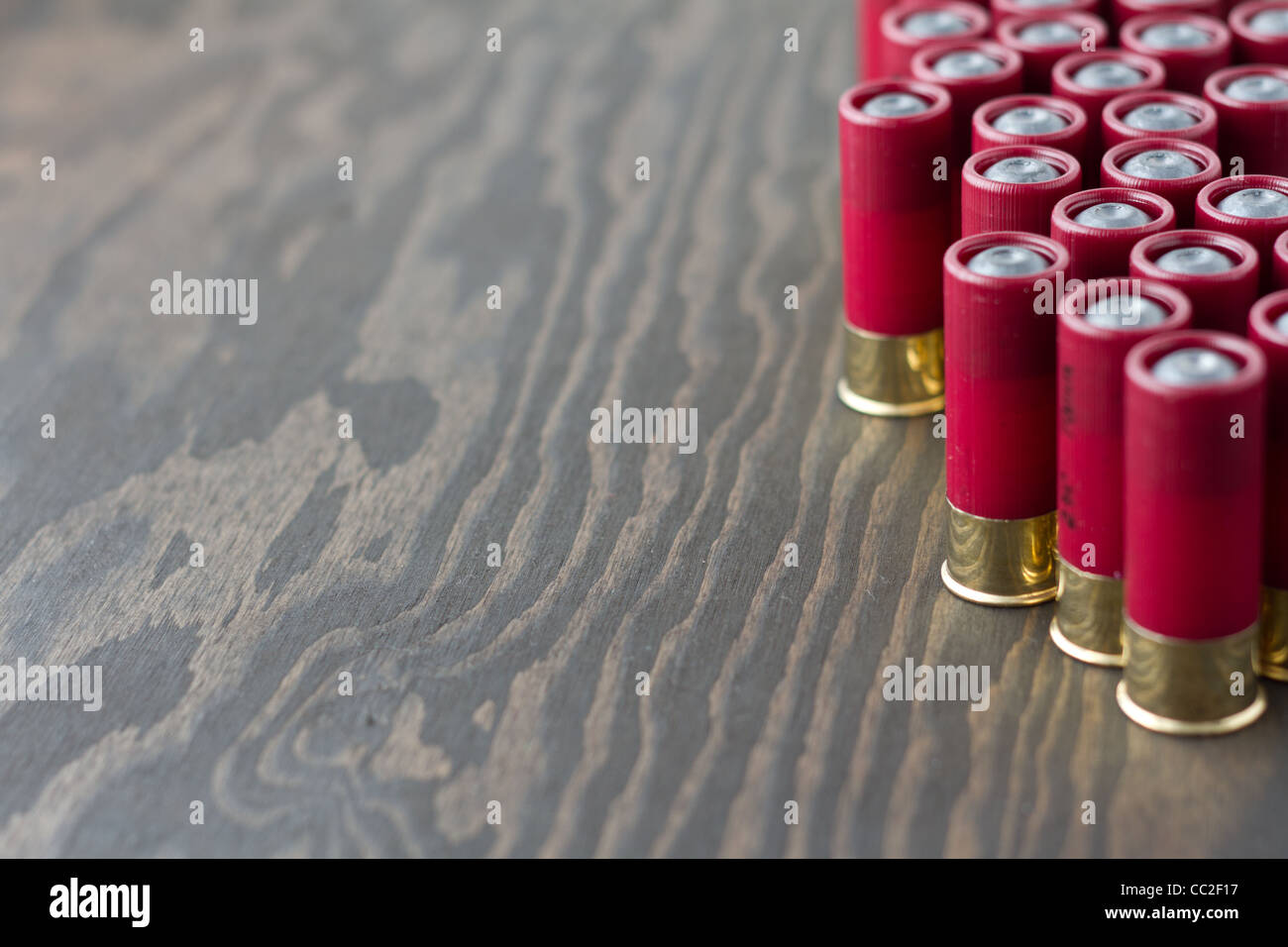12 gauge shotgun shells on wooden surface Stock Photo - Alamy