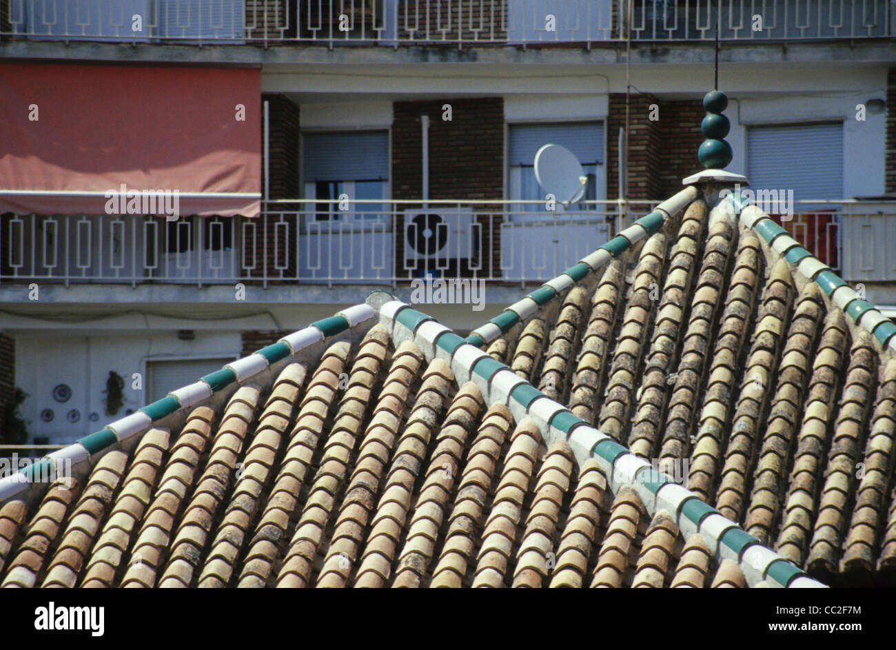 Traditional tiled roofs with a modern residential block in the ...