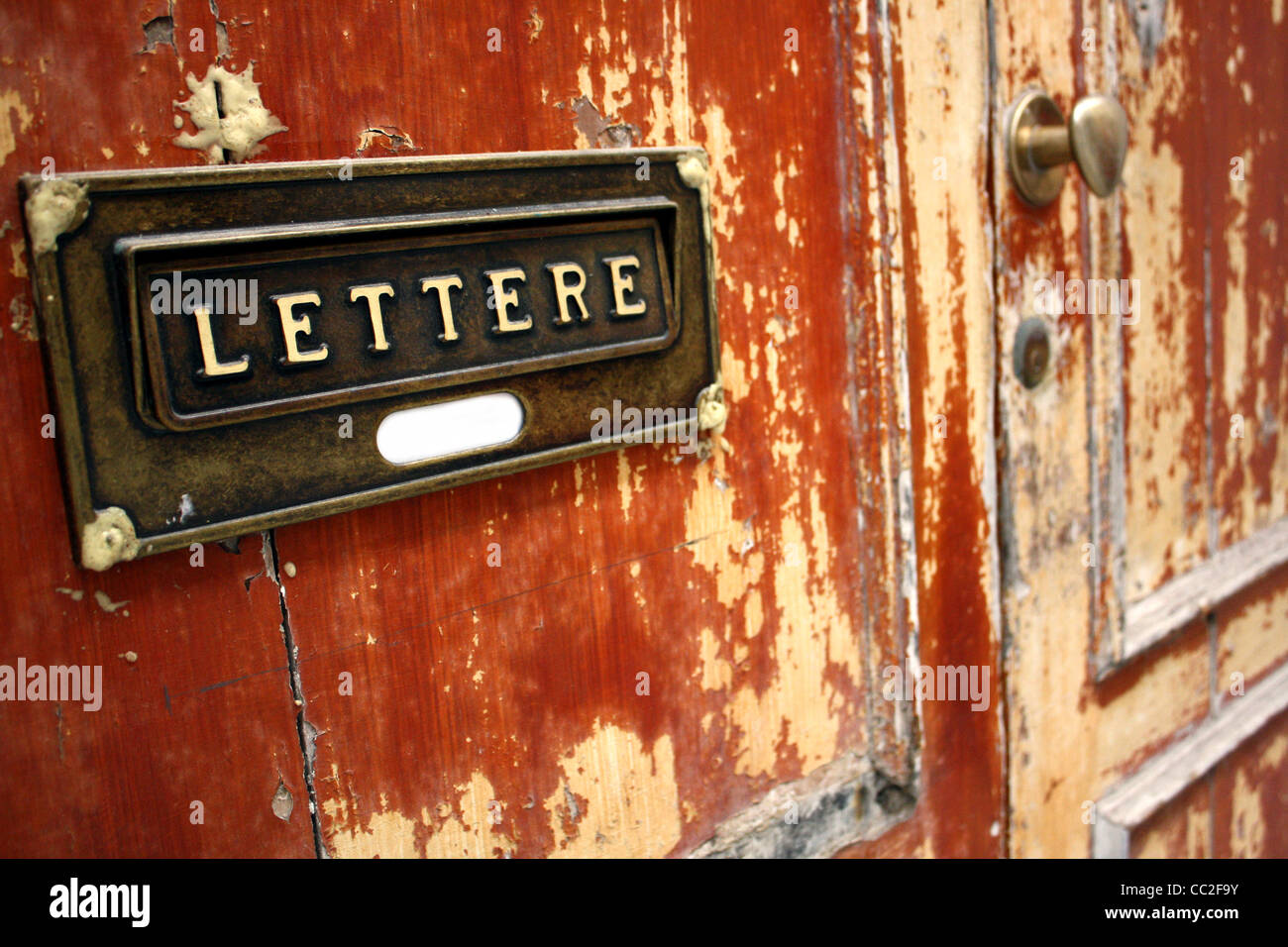 Close-up of a letter box on a rustic door in Italy. Reads 'Lettere ...